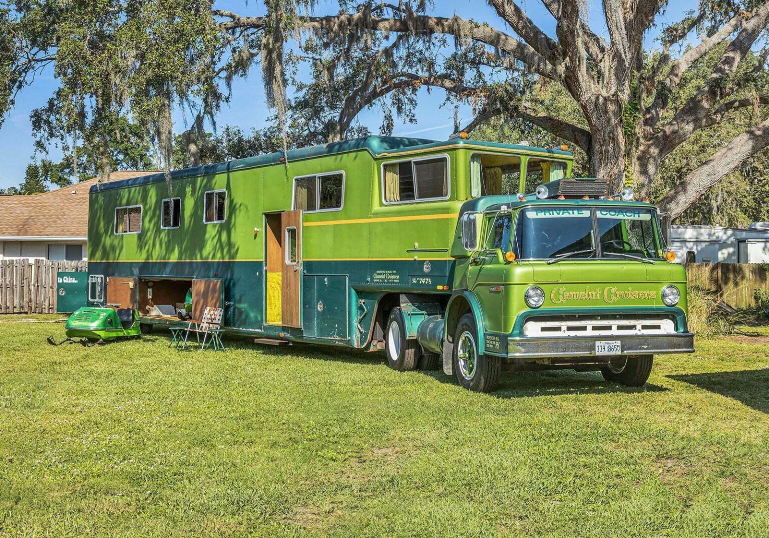 A Camelot Cruiser Motorhome With Matching Poloron Snowmobiles